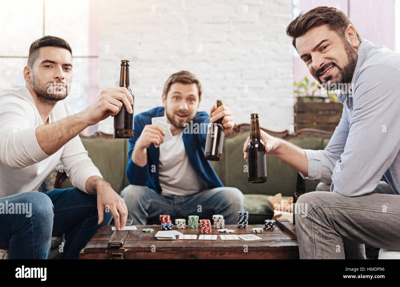 Handsome brutal men raising their bottles of beer Stock Photo - Alamy