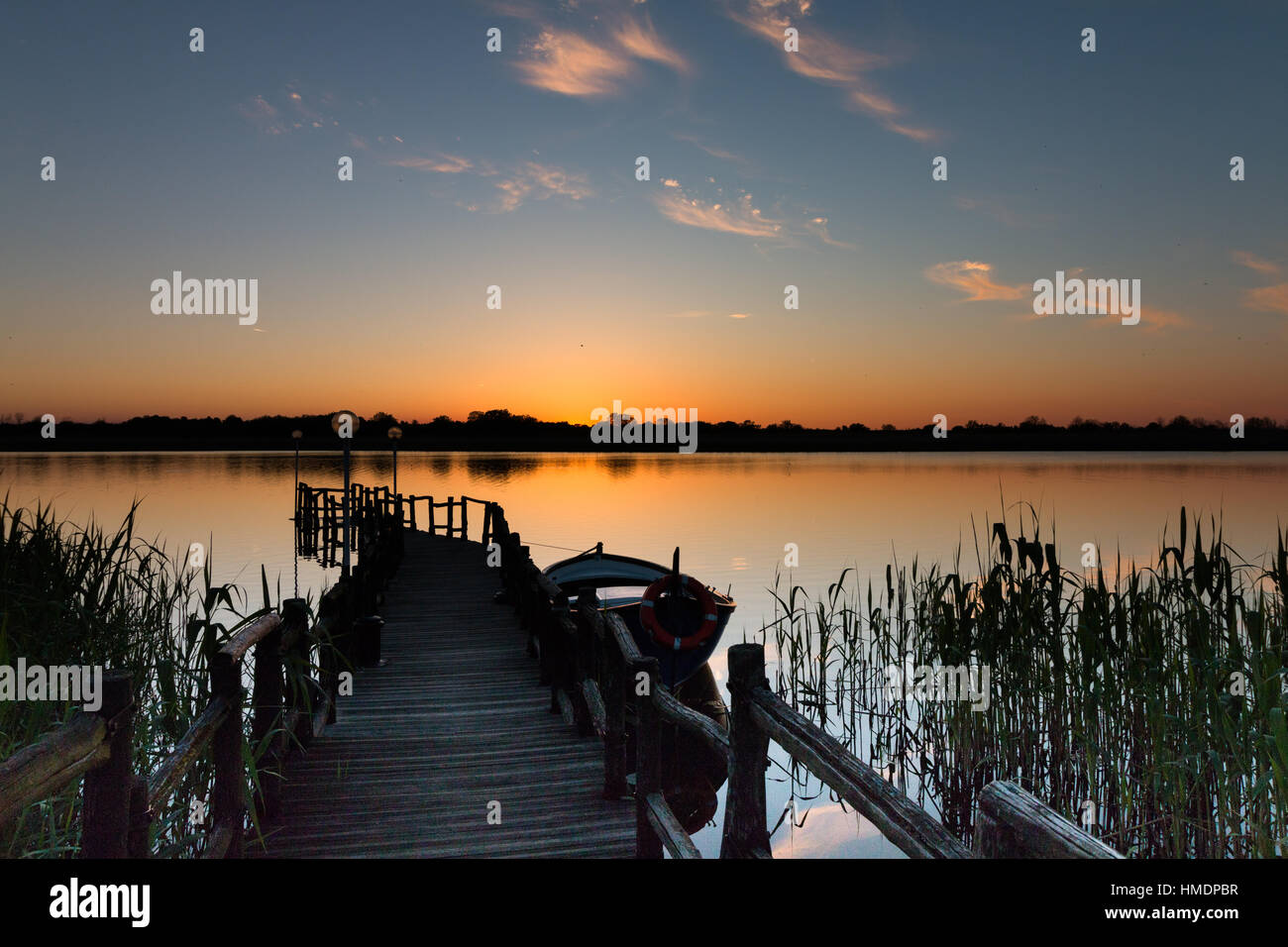 Beautiful sunset at the small dock in "Shabla Lake". Epic clouds and ...