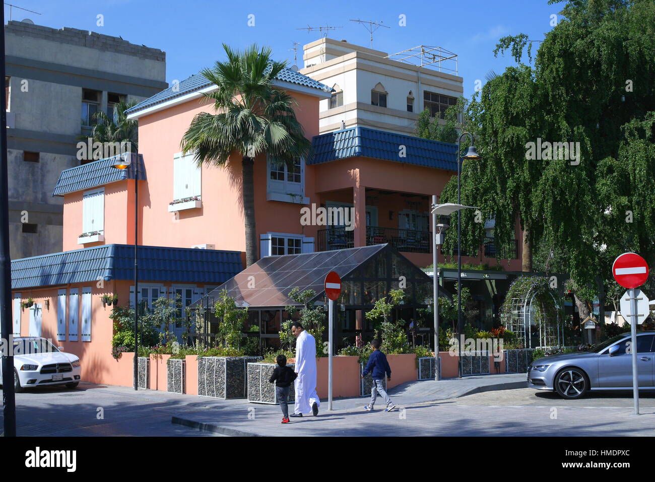 A father and sons walk past a cafe in the entertainment and cultural ...