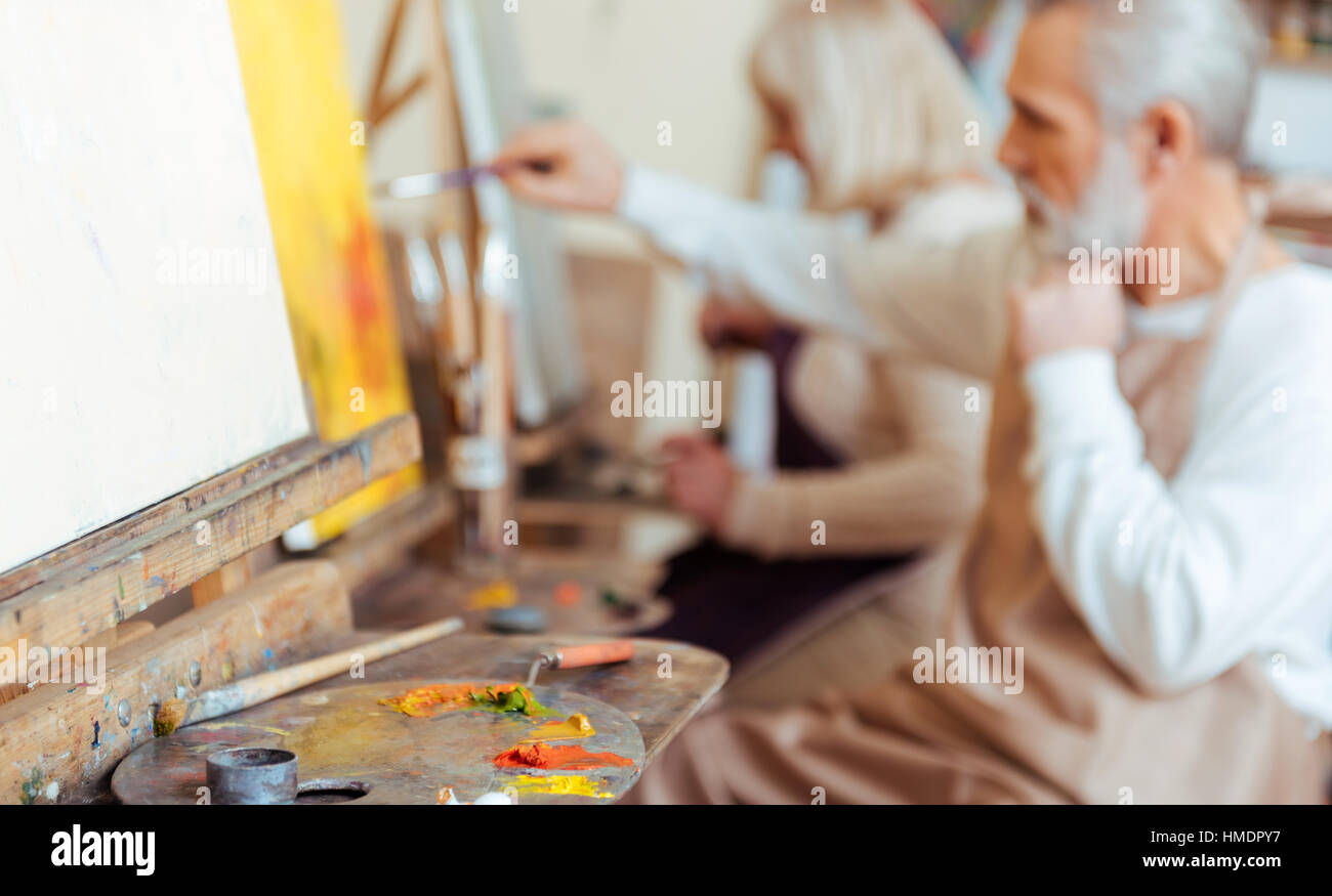 Delighted artist drawing in painting class Stock Photo - Alamy
