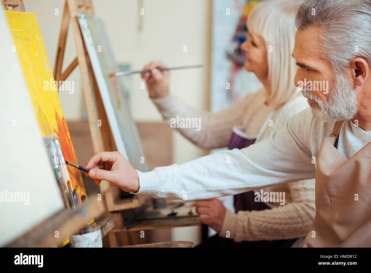 Two talented colleagues painting together in class Stock Photo - Alamy