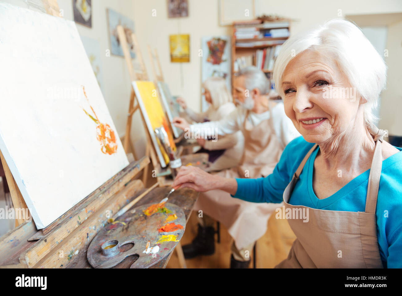 Female artist smiling in painting studio Stock Photo - Alamy