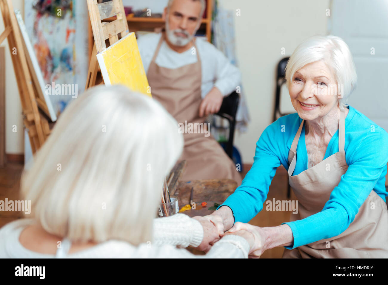 Female artists talking in painting class Stock Photo - Alamy