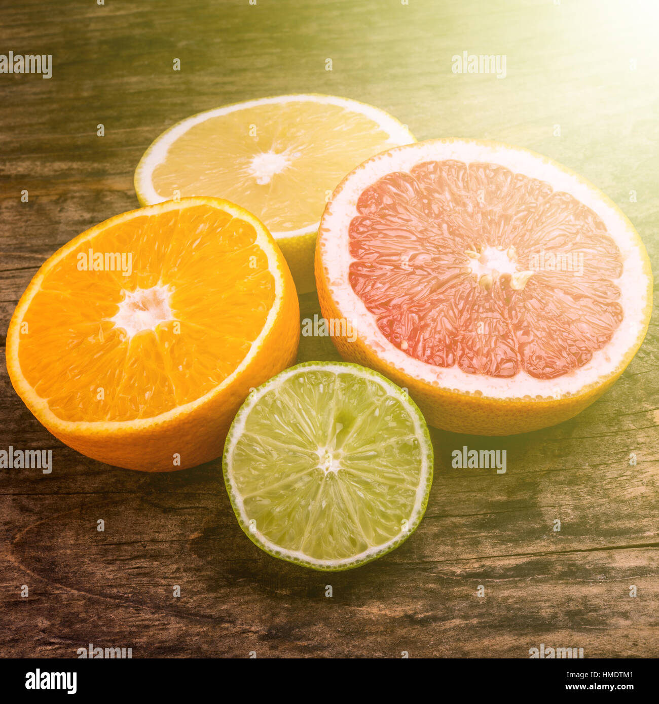 sliced citrus fruits on wooden table Stock Photo - Alamy