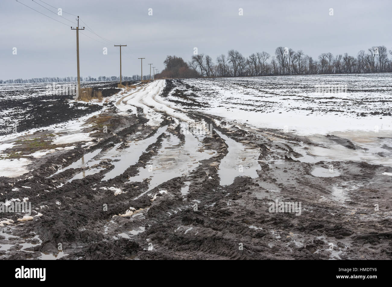 Landscape with dirty country road between agricultural fields in ...