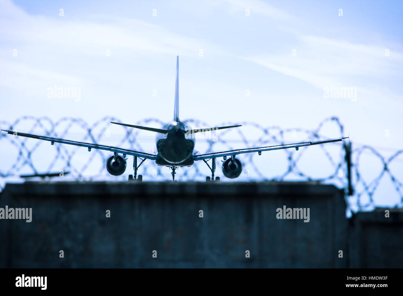 Jet airplane flying overhead close-up on a blue sky background Stock ...