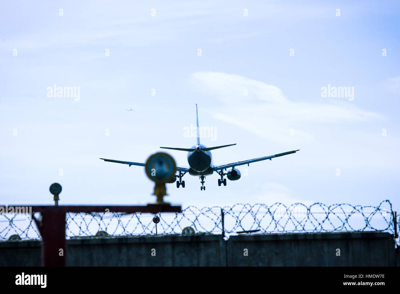 Jet airplane flying overhead close-up on a blue sky background Stock ...
