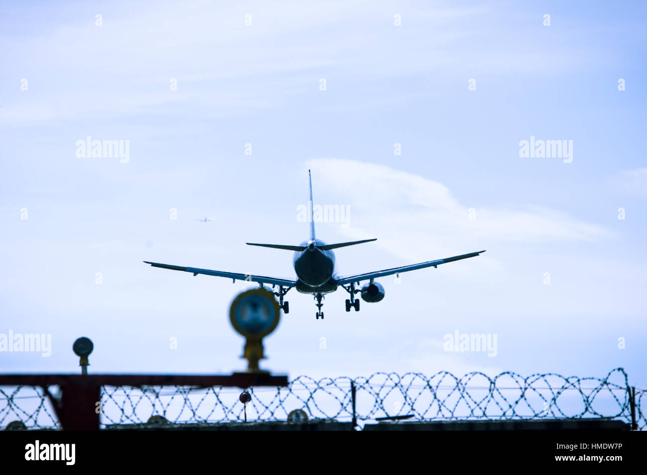 Jet airplane flying overhead close-up on a blue sky background Stock ...