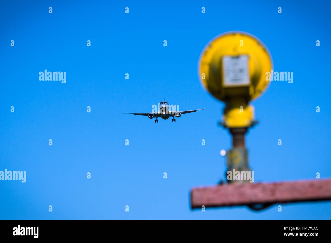 Jet airplane flying overhead close-up on a blue sky background Stock ...