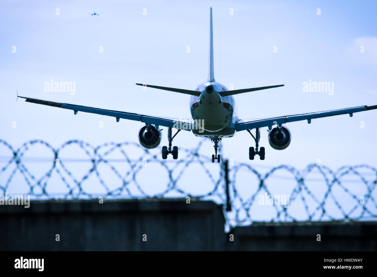 Jet airplane flying overhead close-up on a blue sky background Stock ...