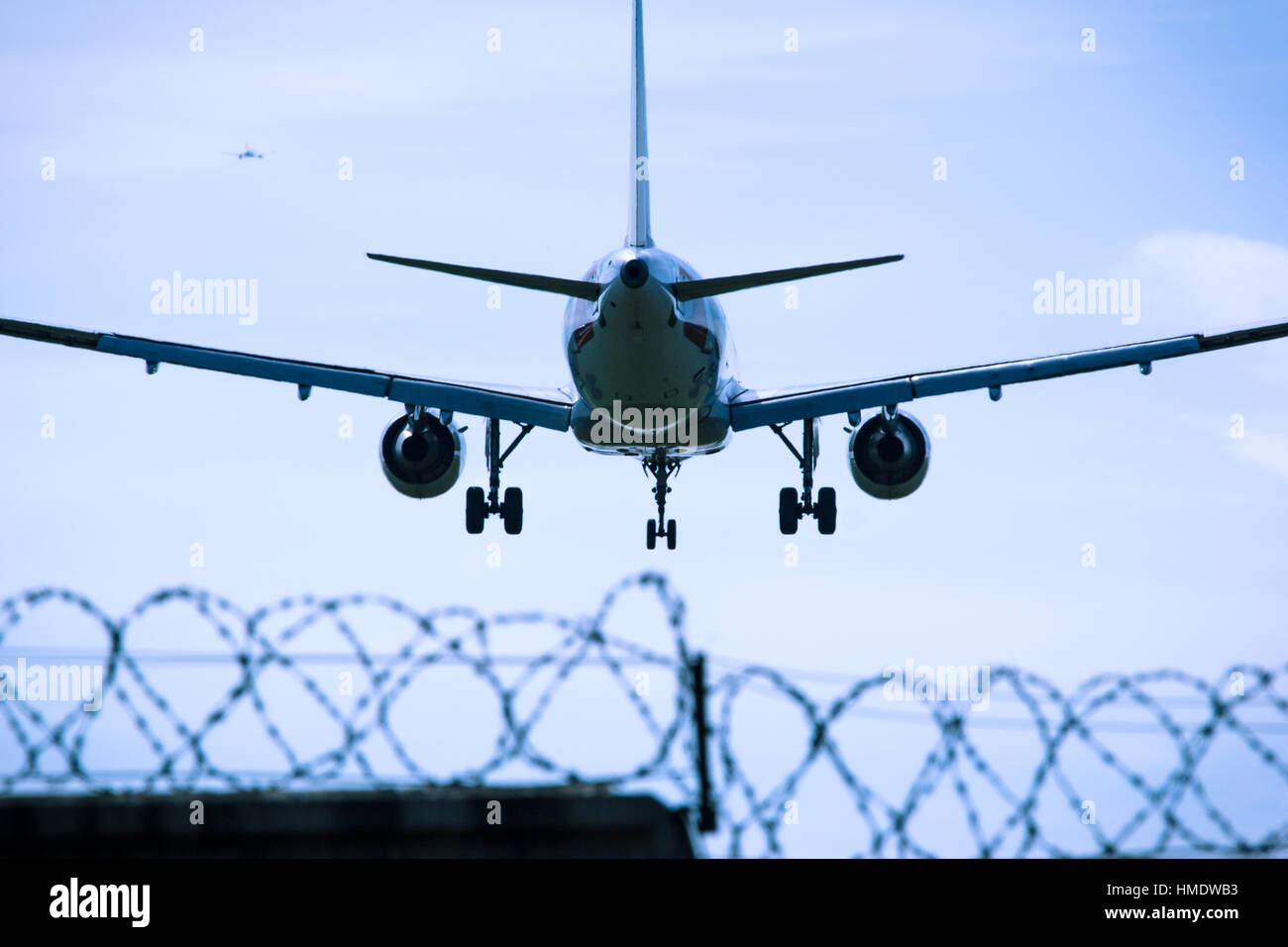 Jet airplane flying overhead close-up on a blue sky background Stock ...