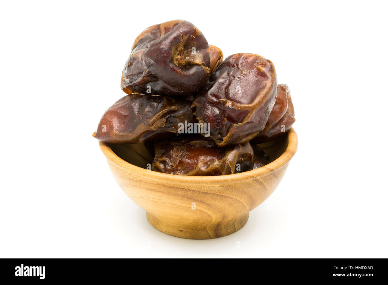 Dried dates fruit in a wooden bowl isolated on white background Stock ...