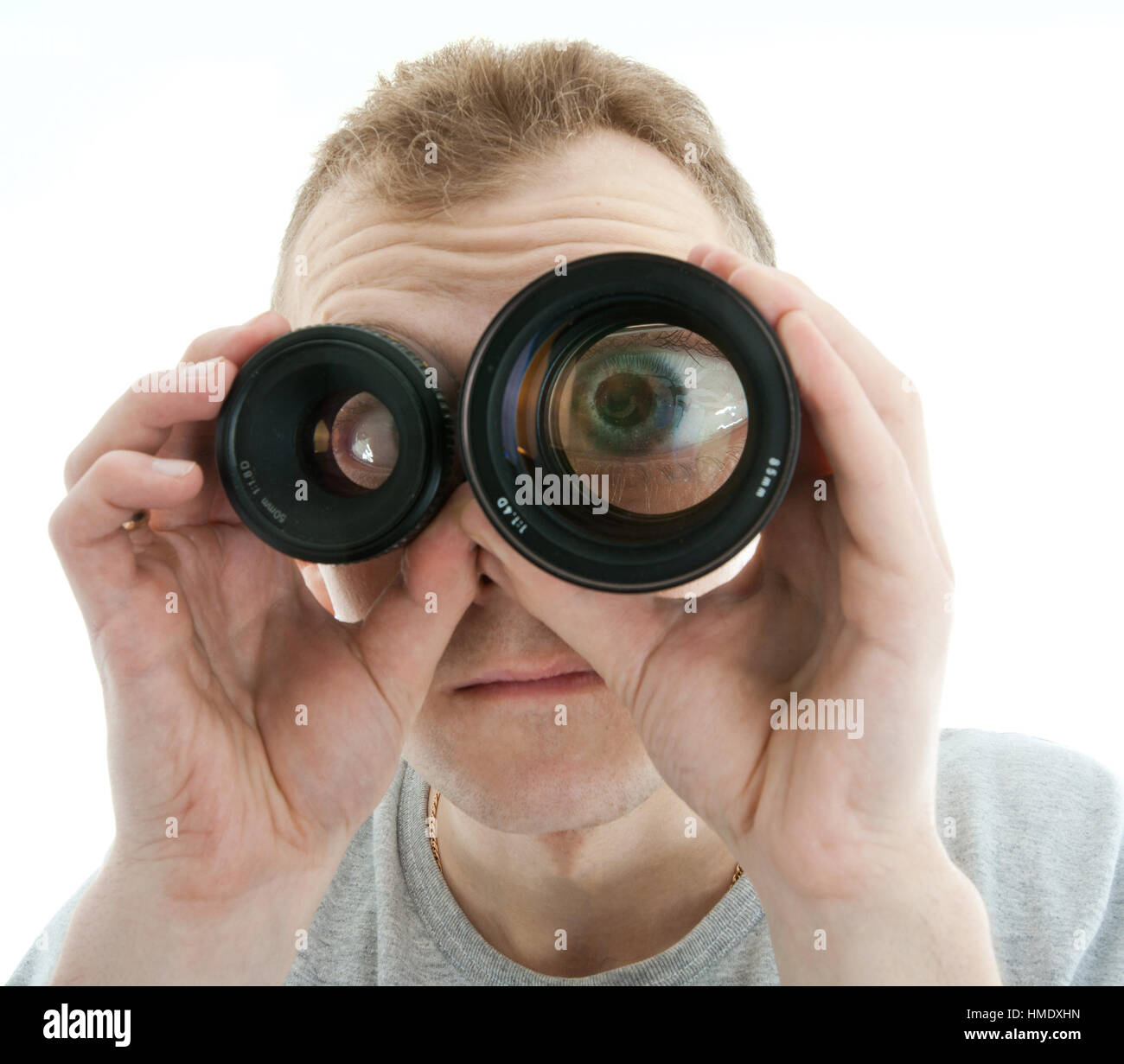 man looking through a lens Stock Photo - Alamy
