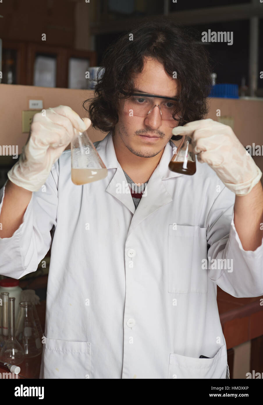 young chemist look at reagent in lab Stock Photo - Alamy