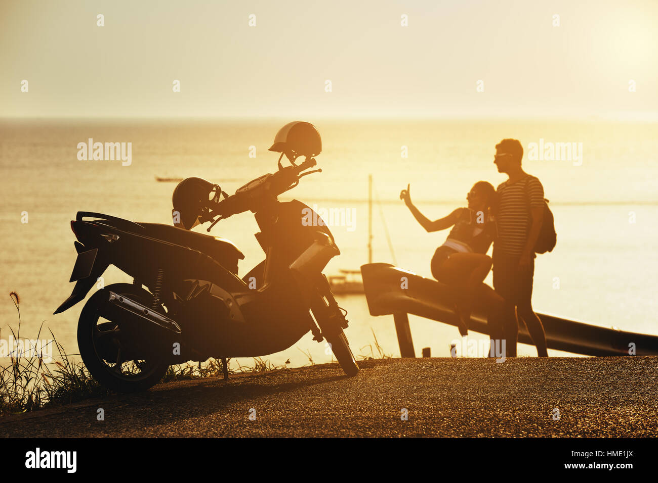 Happy couple sunset sea motorcycle road Stock Photo - Alamy