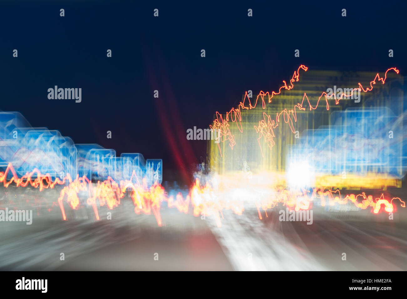 Abstract blur highway background at dusk with road signs and car trails ...