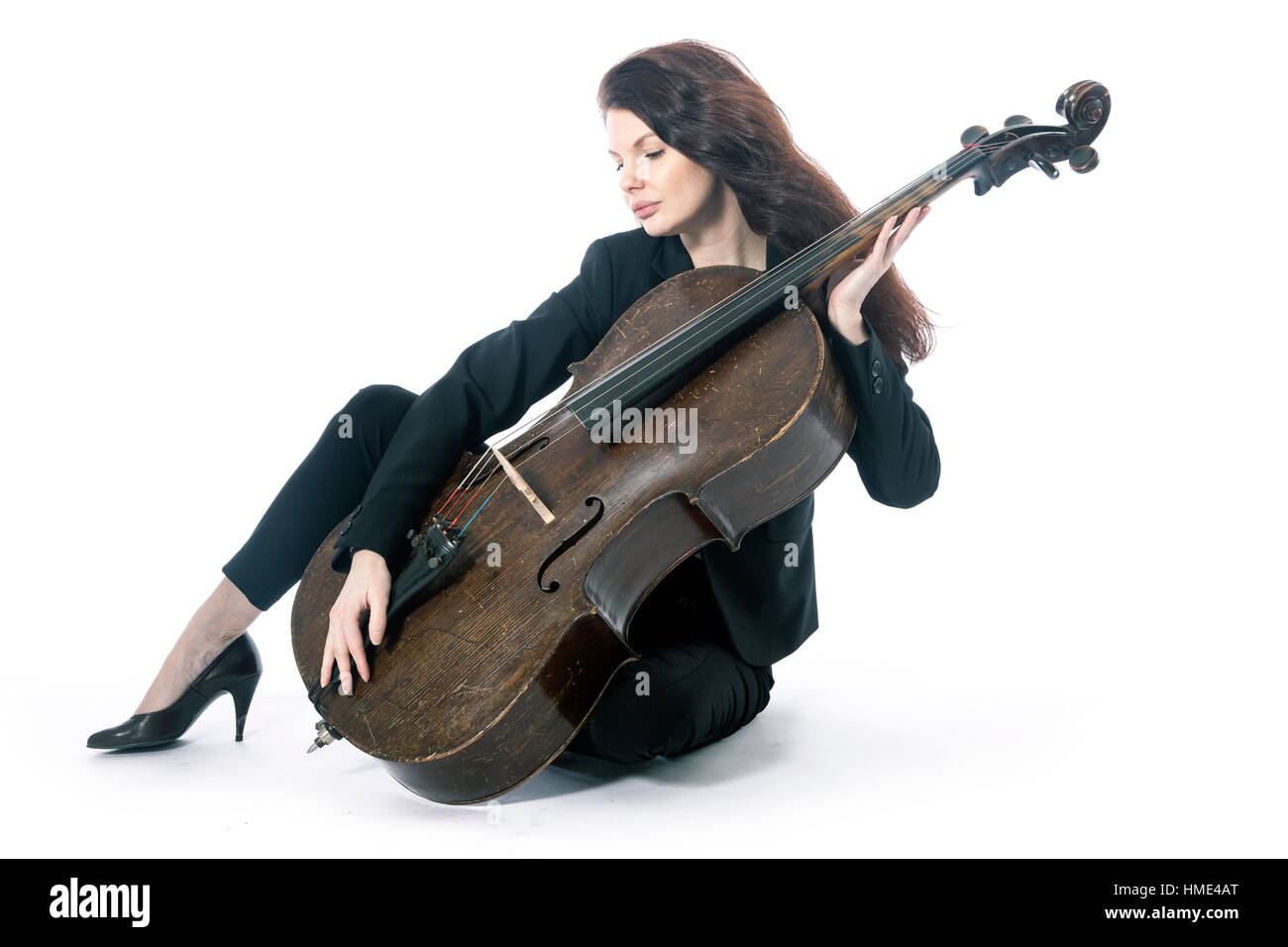 beautiful brunette with cello in studio against white background Stock ...