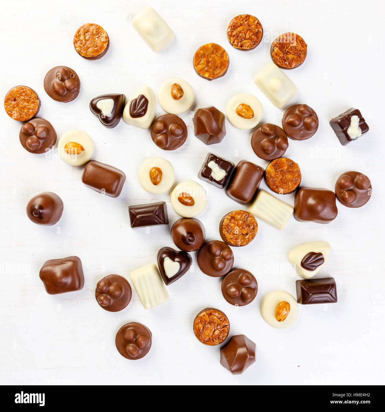 Assortment of delicious chocolate pralines on white table Stock Photo ...