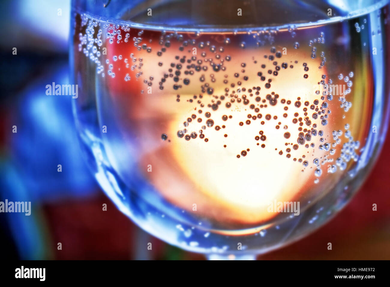 Bubbles in big glass with yellow light Stock Photo - Alamy