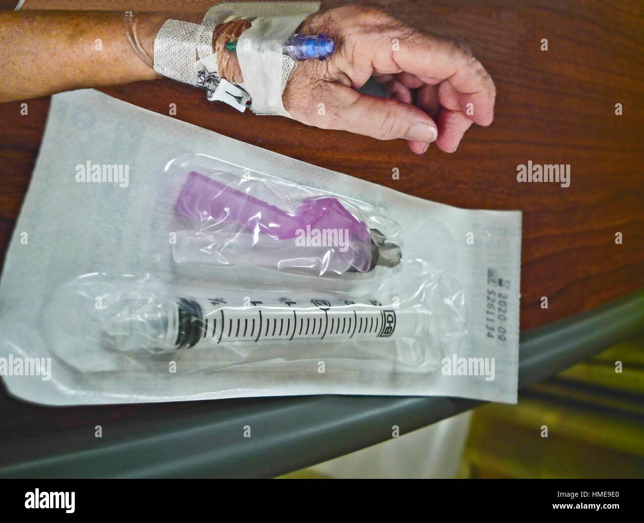 A patient receives an IV (Intravenous therapy) in a hospital prior to ...