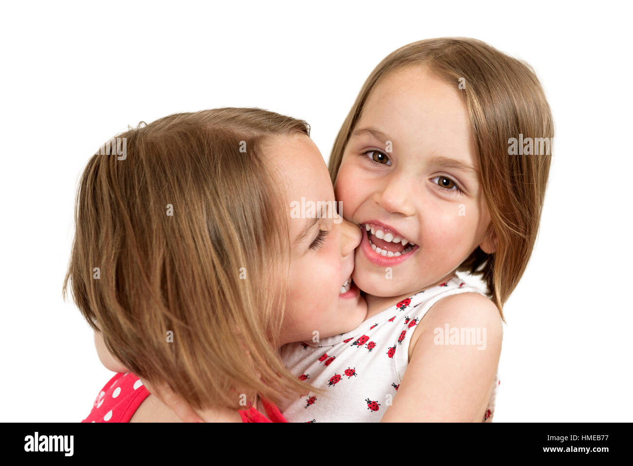 Two smiling twin sisters hugging hi-res stock photography and images ...