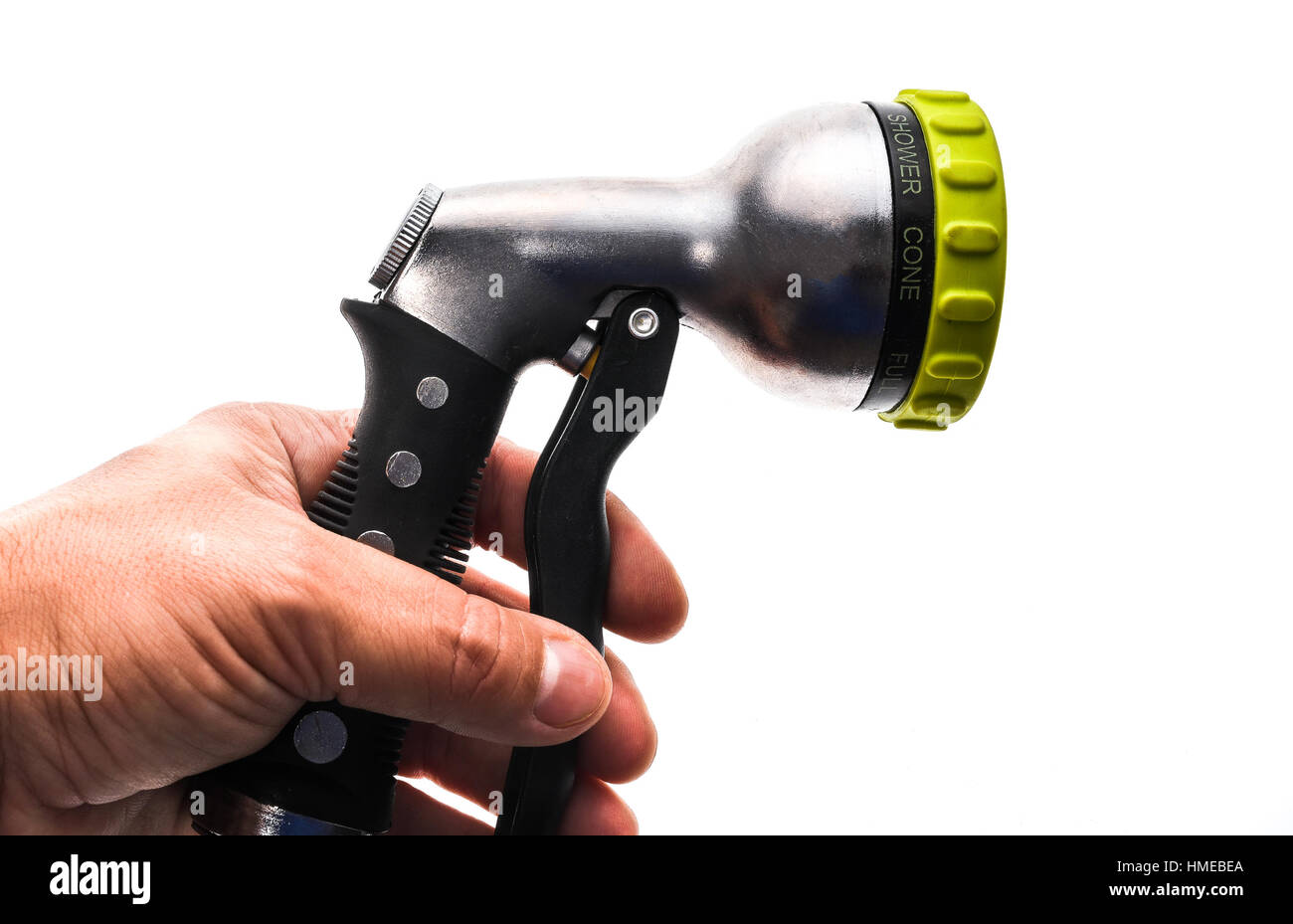 Hand holding a water hose sprinkler with adjustable shower spray ...