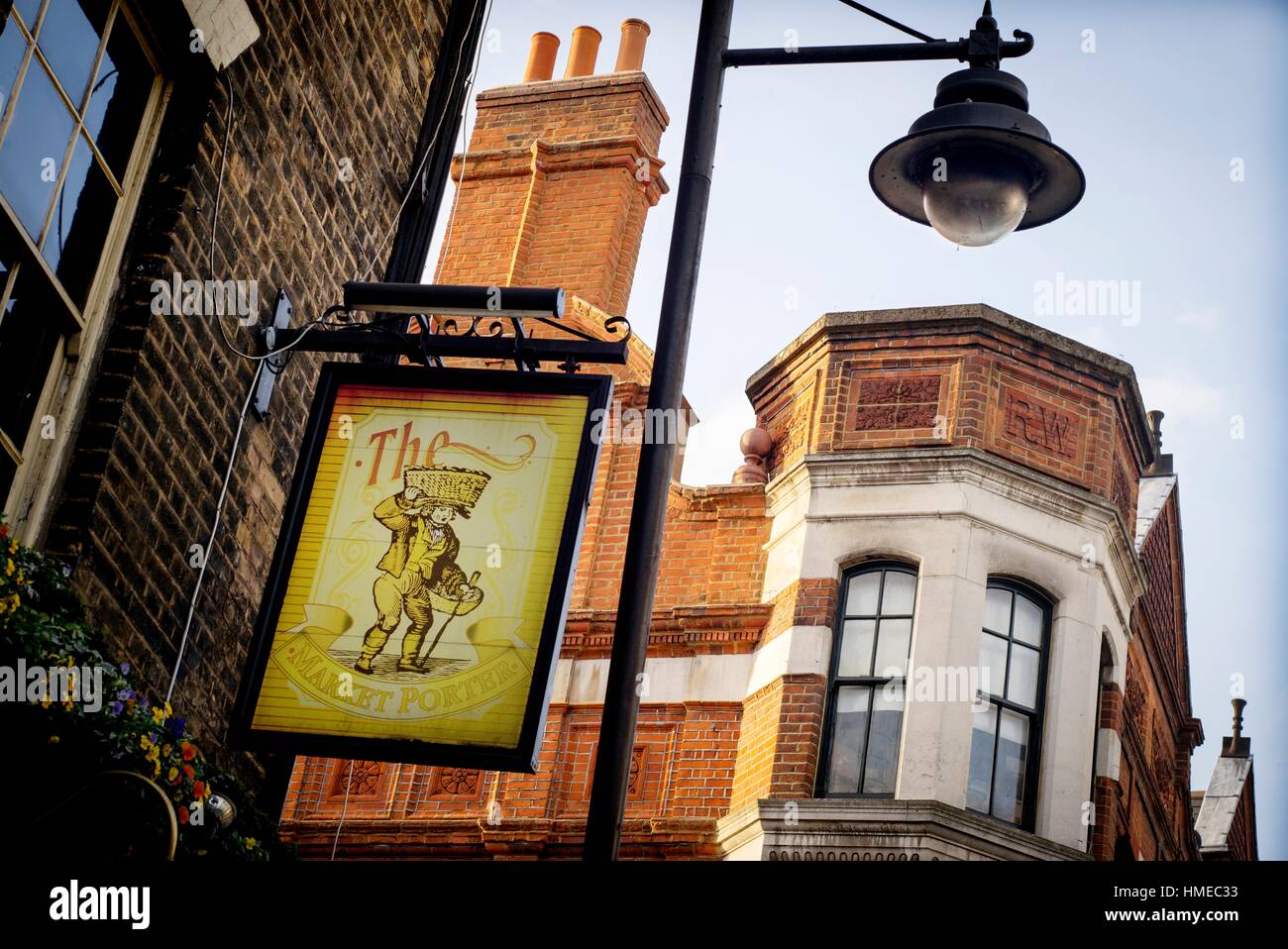 Close up of the "The Market Porter" pub sign with a street lamp and ...