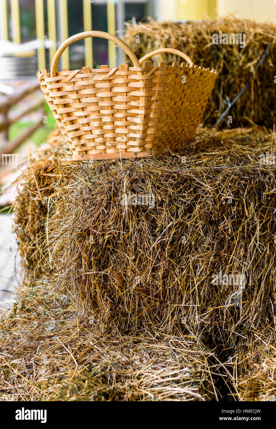 Basket on top of hay stack on a ranch. A typical farming and ...