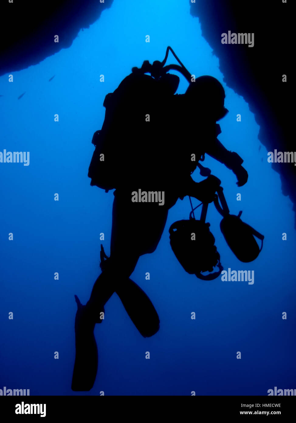 Silhouette of professional underwater photographer in front of ...