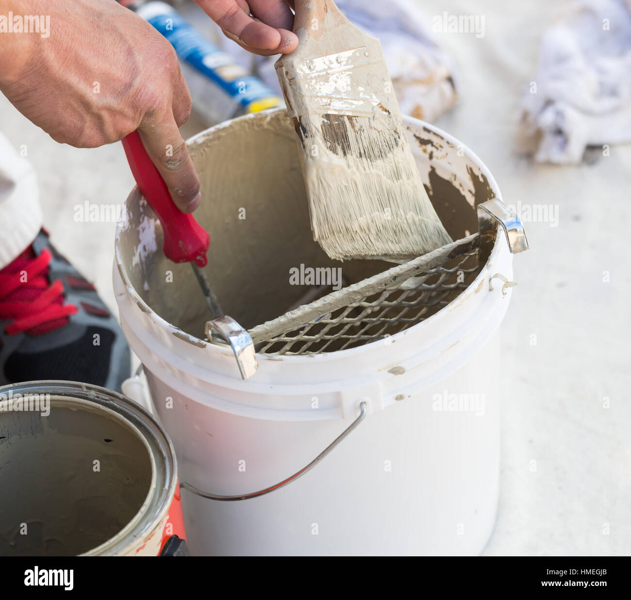 Professional Painter Loading Paint Onto His Brush From A Bucket Stock ...