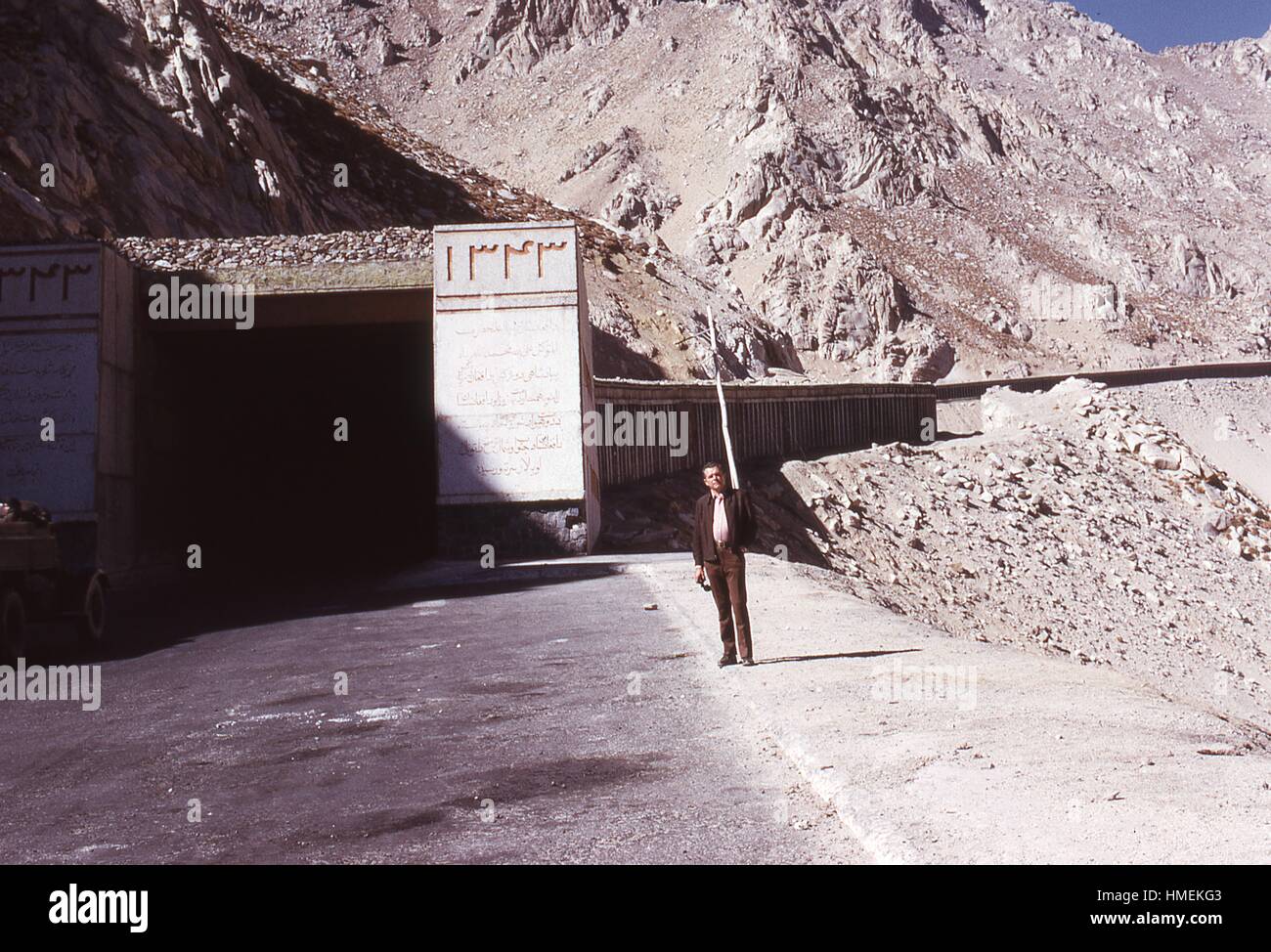 Western man poses outside of the entrance to the Salang Tunnel, located ...