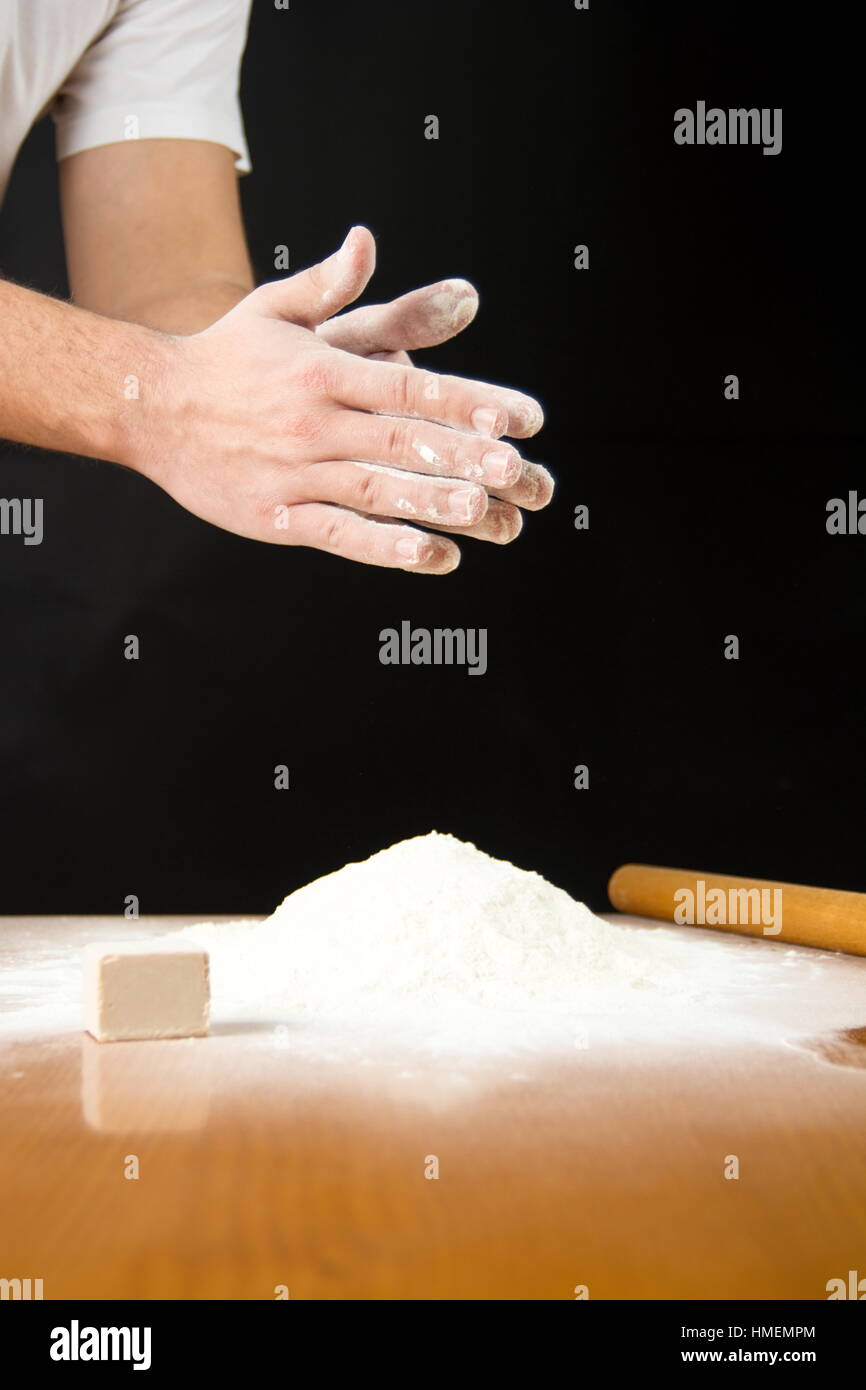Male baker shaking out flour from hands Stock Photo - Alamy