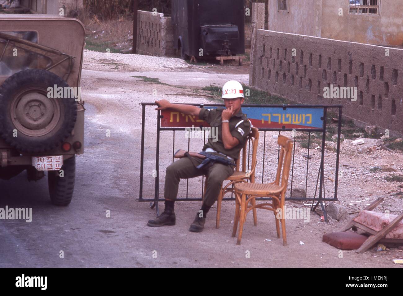 Israeli border police officer sitting at the checkpoint crossing fence ...