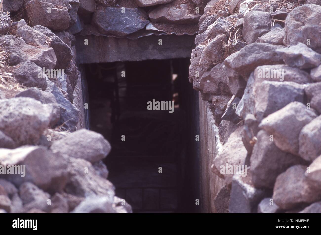 Stacked rock wall entrance to underground bunker room in the town of ...