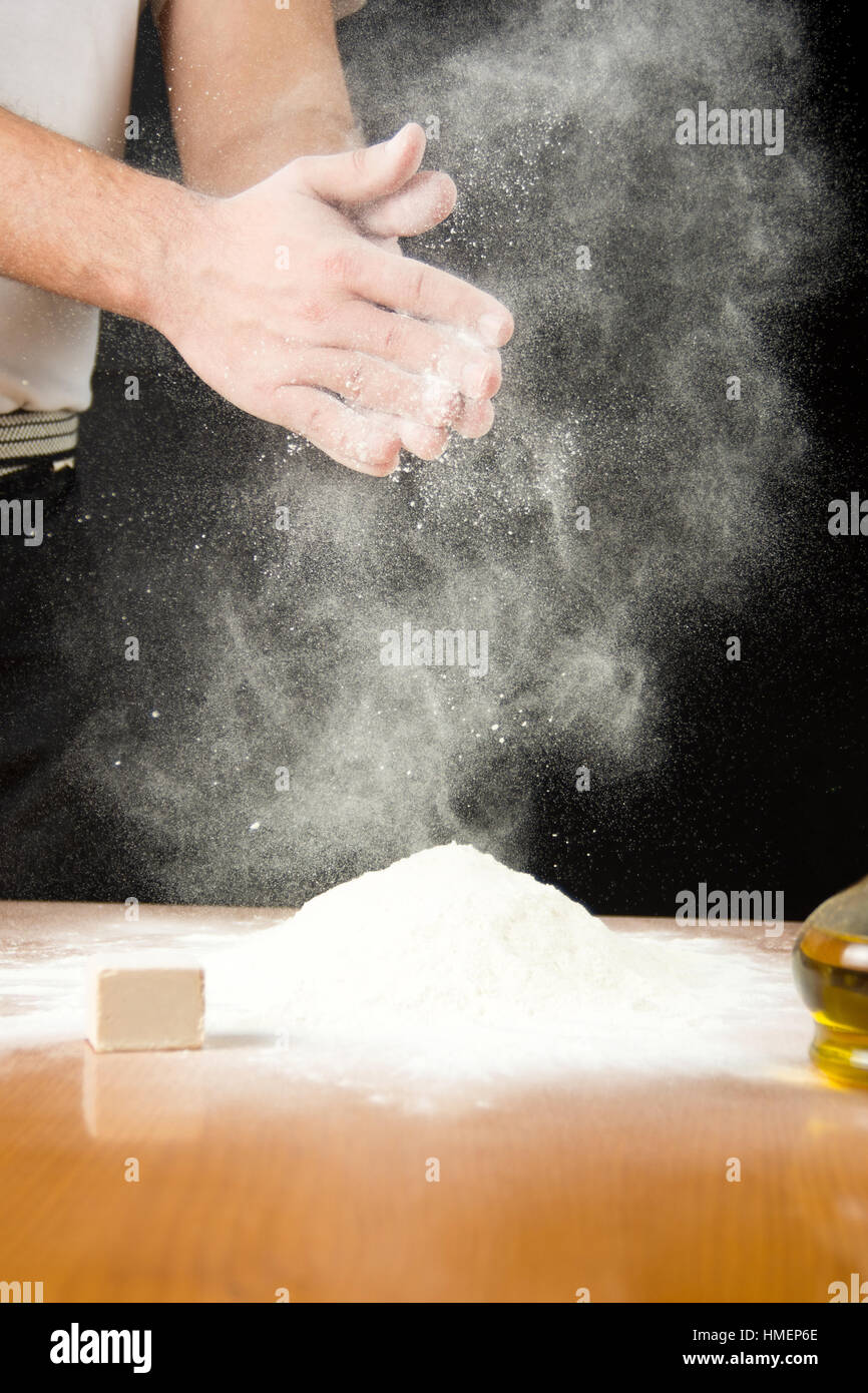 Man shaking of flour from his hands Stock Photo - Alamy
