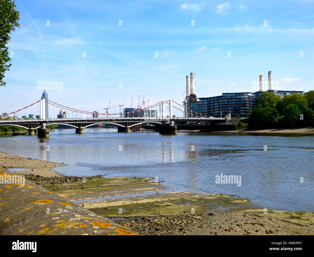 Thames riverside at Battersea, Chelsea Bridge at low tide, London. May ...