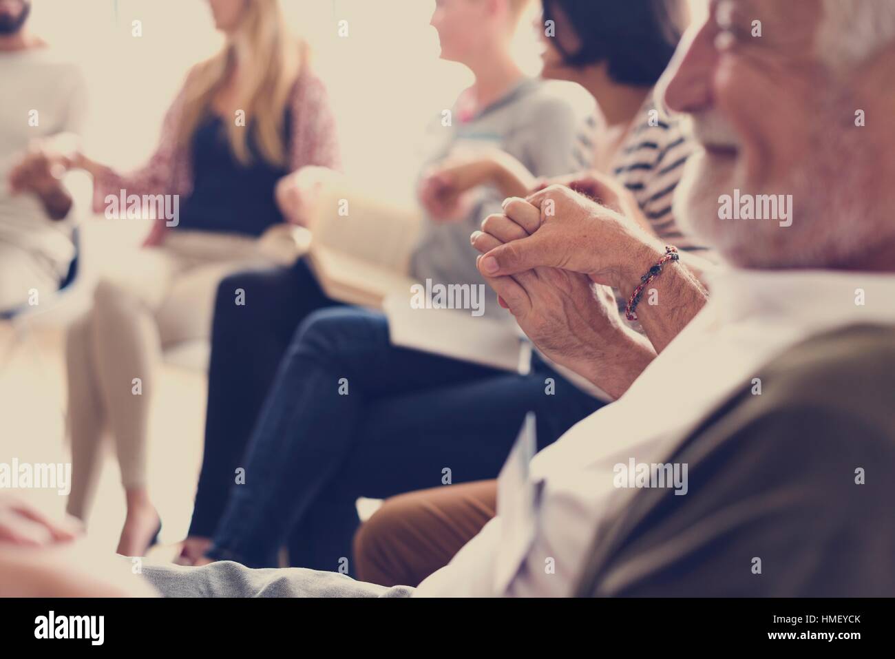 People in a counseling holding hands Stock Photo - Alamy