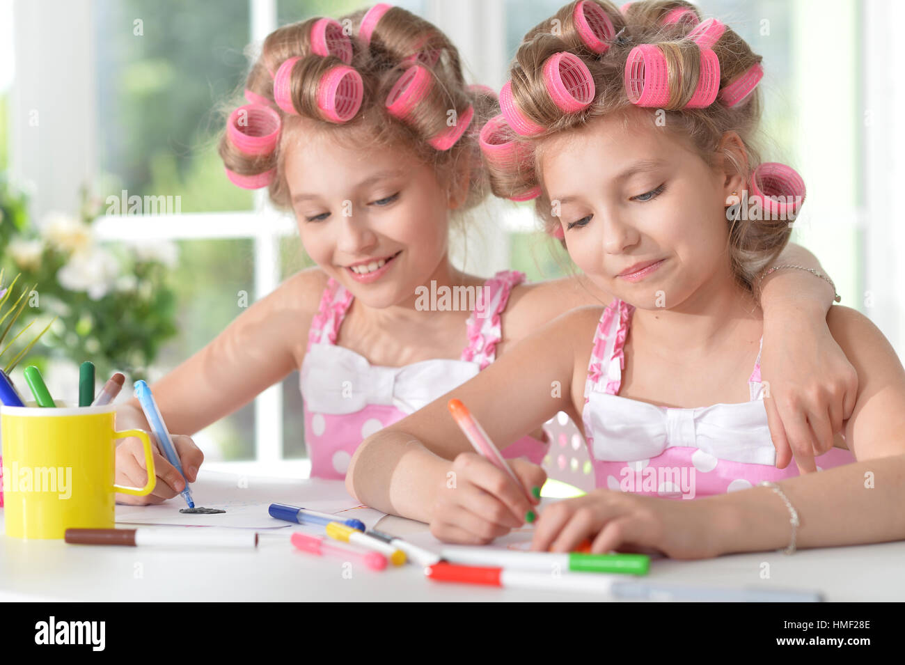 two sisters twins drawing Stock Photo - Alamy