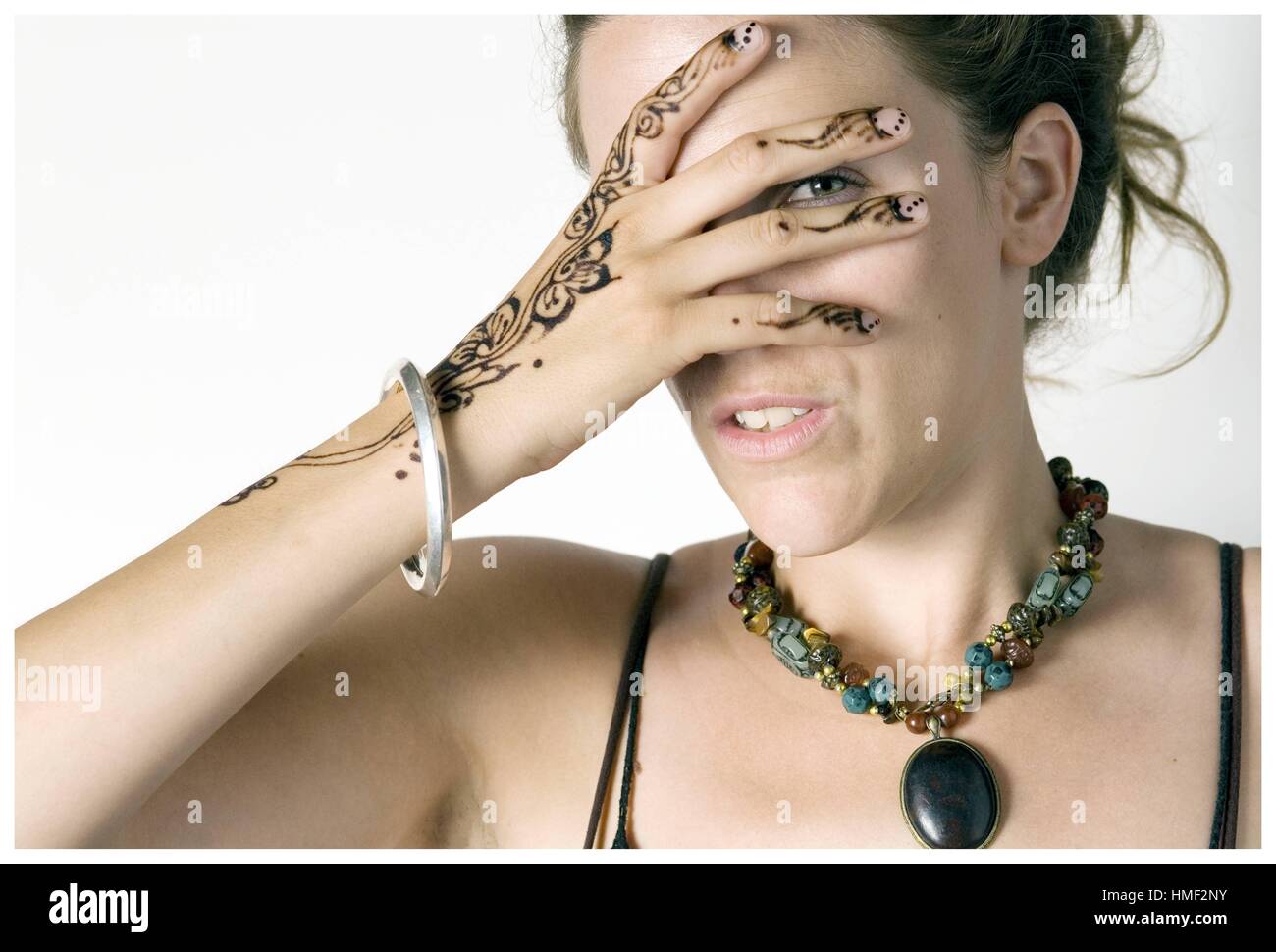 Woman hand covering tattoo hi-res stock photography and images - Alamy