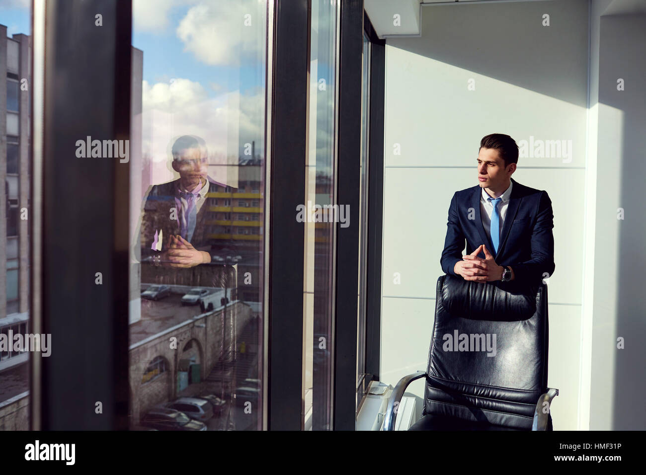 Businessman by window in the office. Business portrait Stock Photo - Alamy