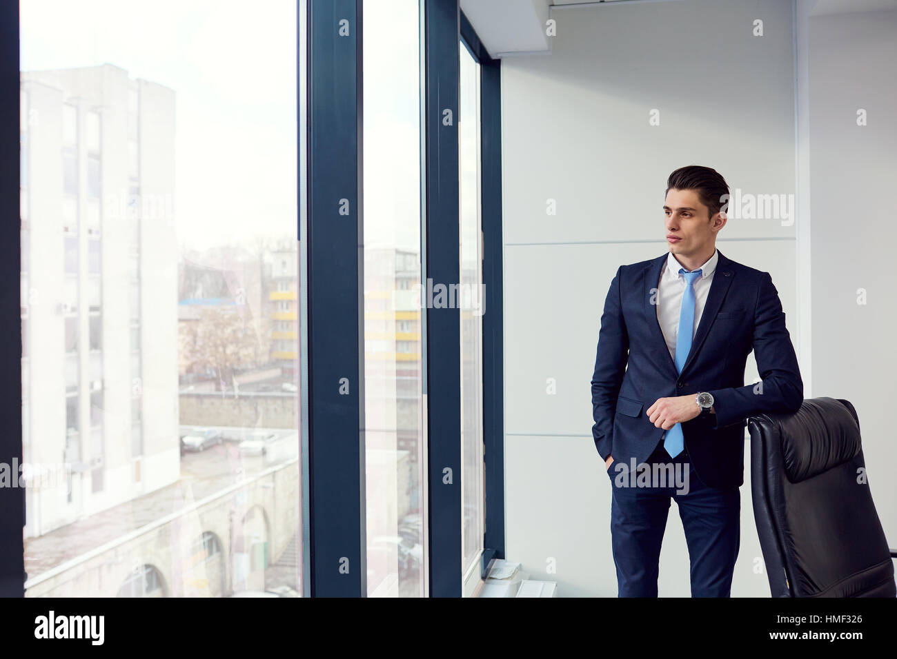 Businessman by window in the office. Business portrait Stock Photo - Alamy