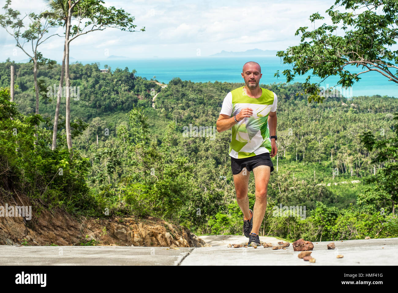 Athletic young man running in the nature. Thailand Stock Photo - Alamy
