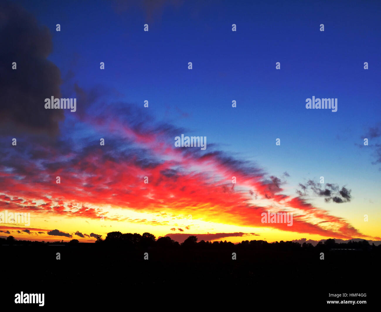 Fiery sunset sky over a rural area at the countryside Stock Photo - Alamy