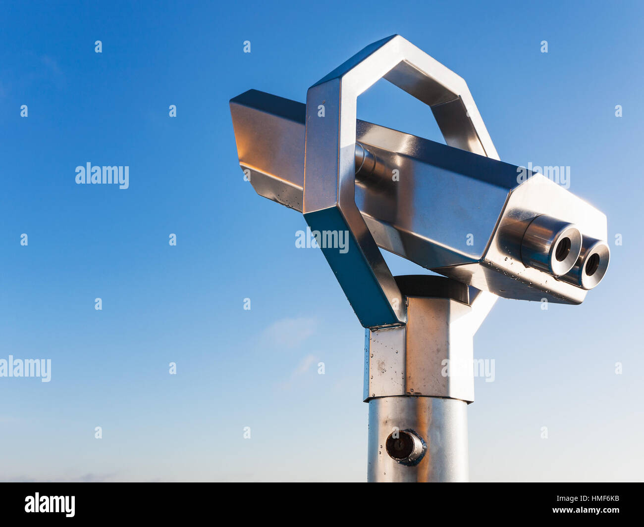stationary observation binoculars and blue sky in sunny day Stock Photo ...