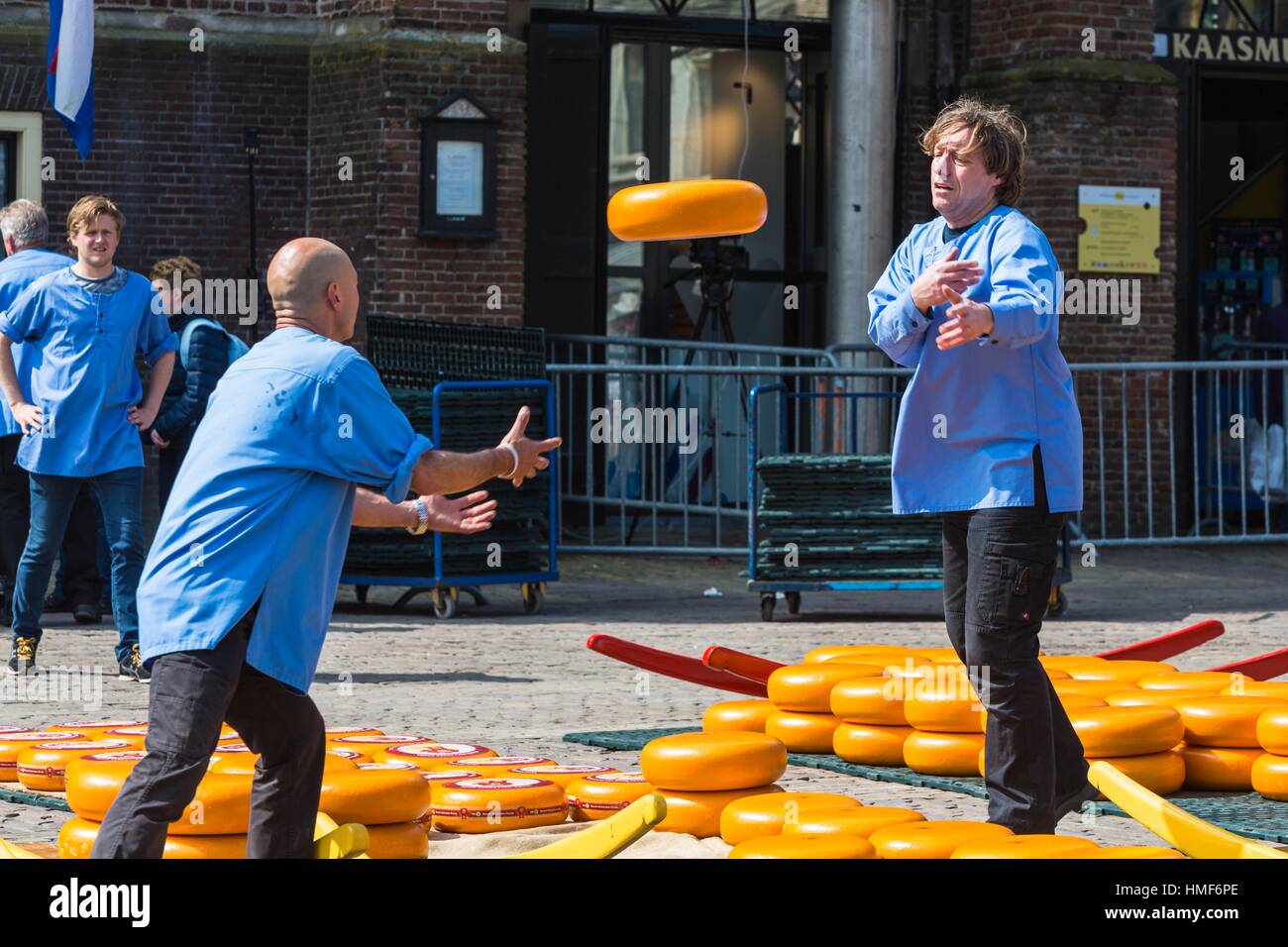 Two men throwing and catching a wheel of cheese at the famous cheese ...
