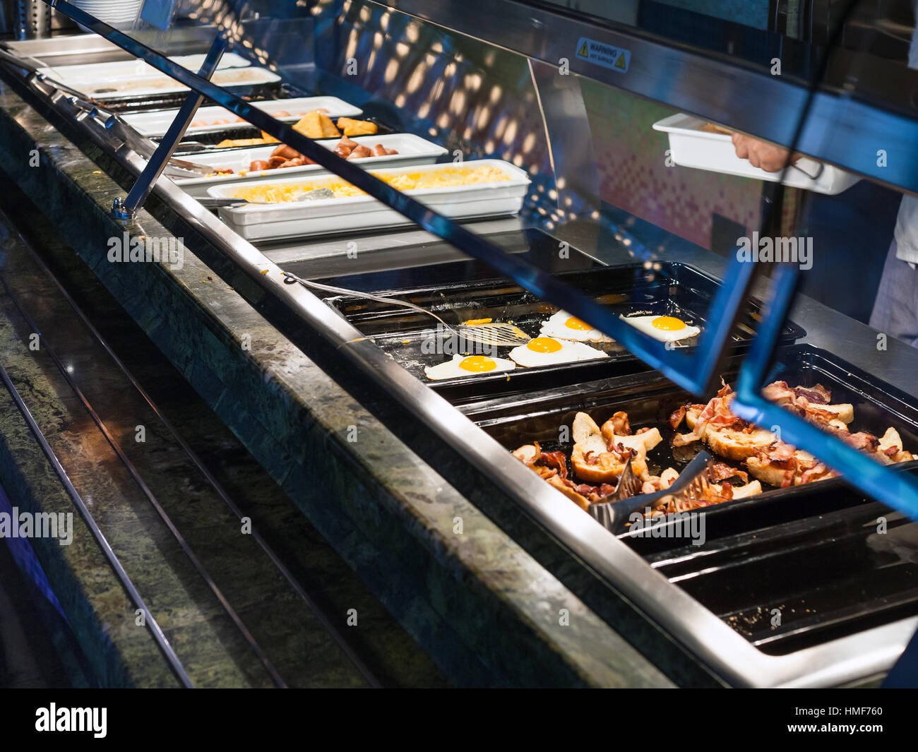 self-service buffet with hot american breakfast - bacon, fried eggs ...