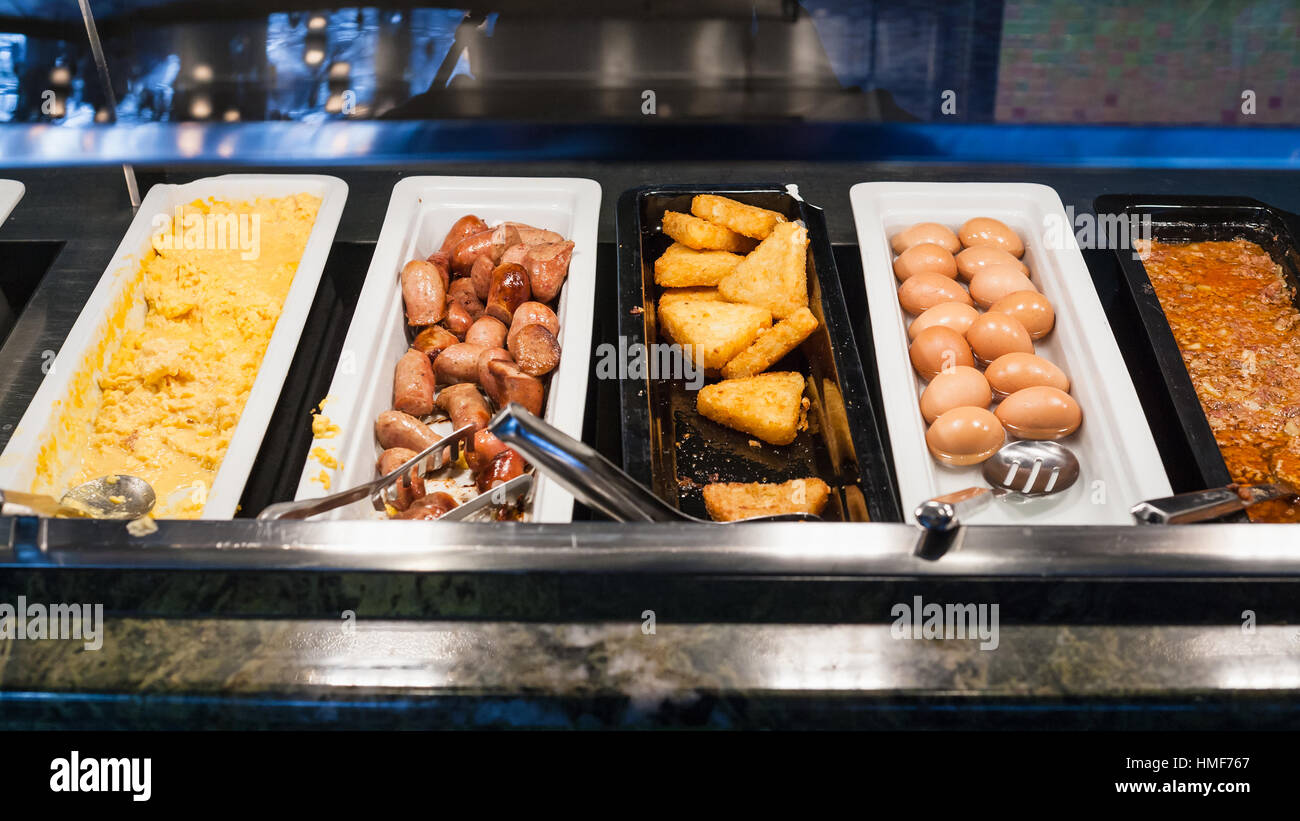 self-service buffet with meals for breakfast - bacon, scrambled eggs ...