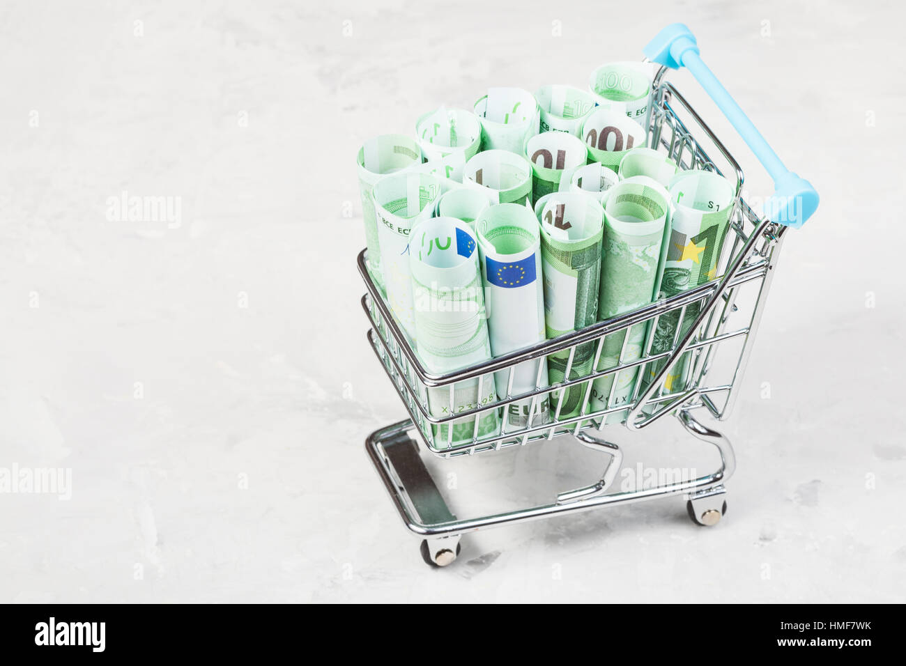 bascart with rolls from euro banknotes on concrete board Stock Photo ...