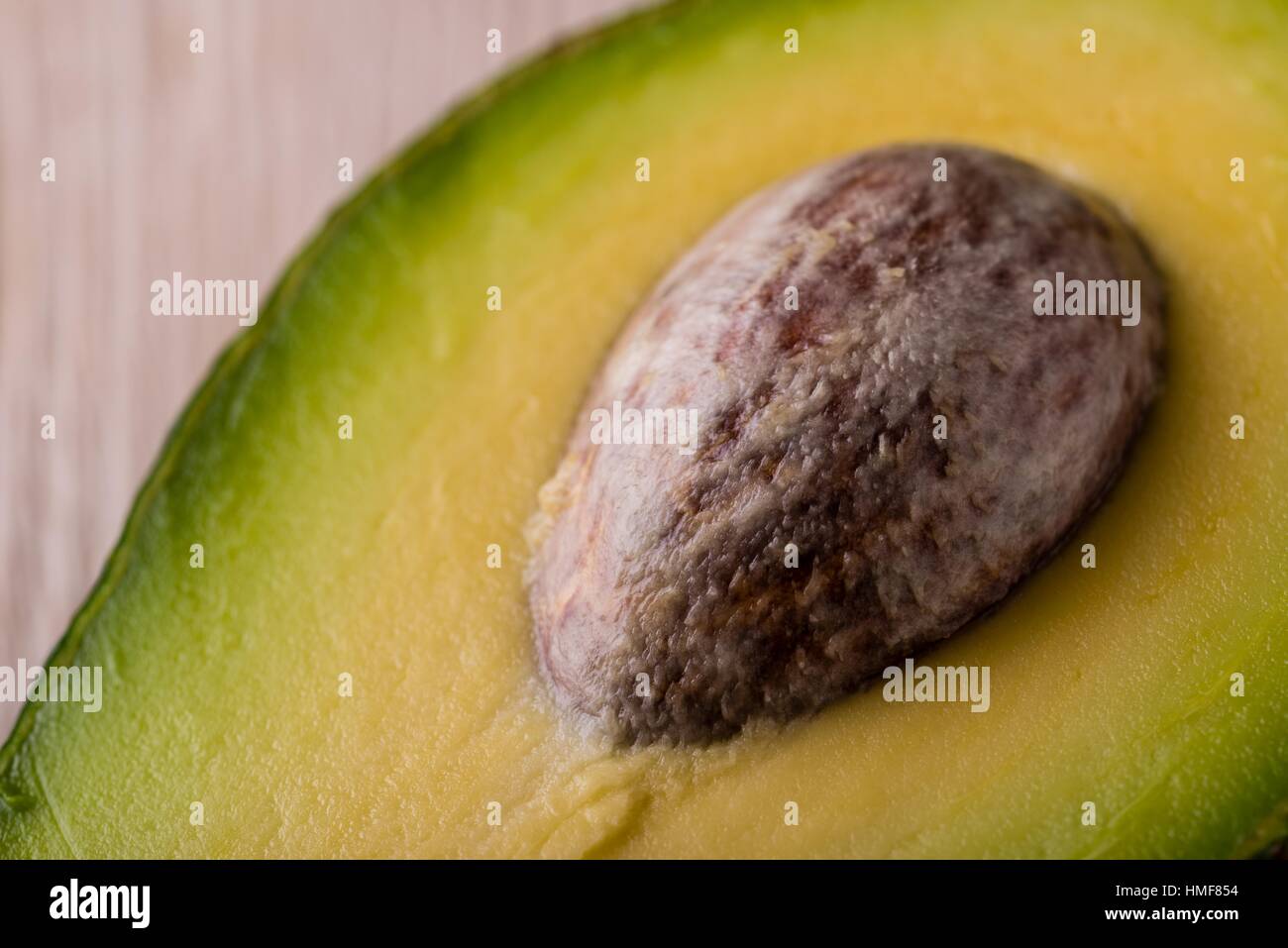 Horizontal photo with detail of big brown avocado core still placed in ...