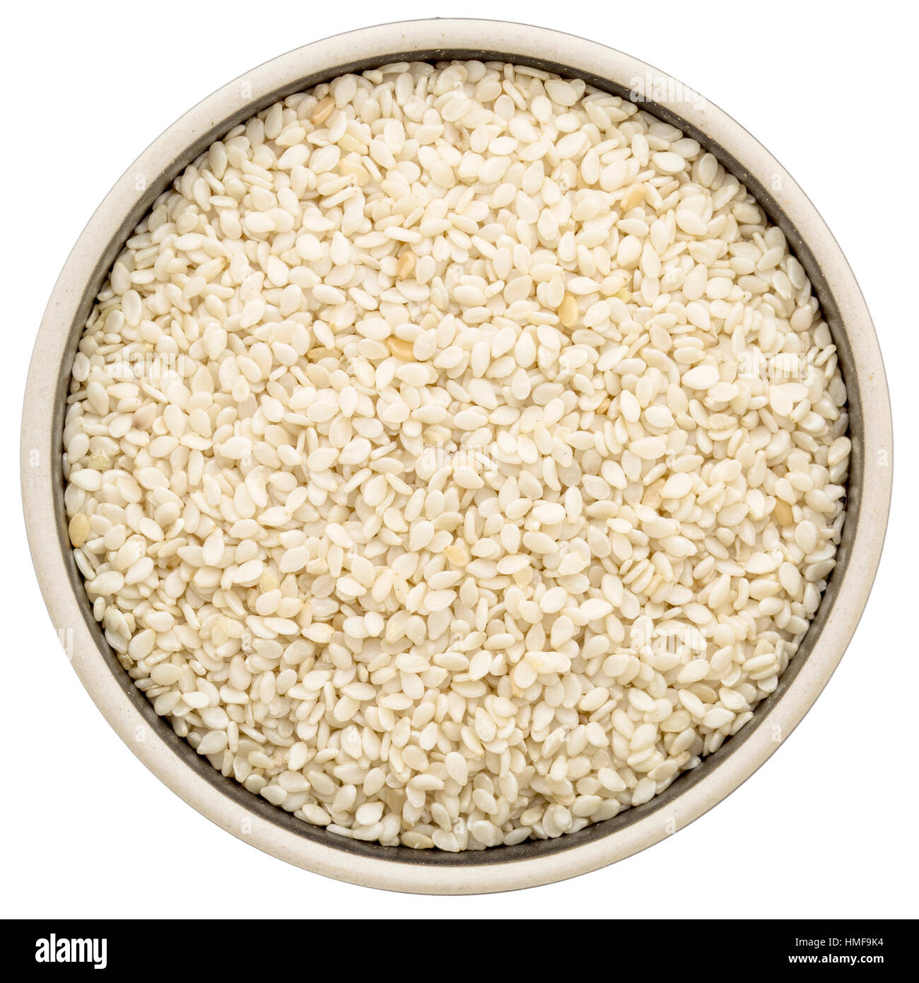 unhulled sesame seeds in a round bowl isolated on white Stock Photo - Alamy